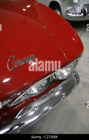 Old red Chevrolet Chevy Corvair Monza coupe 1963 in a warehouse. Front ...