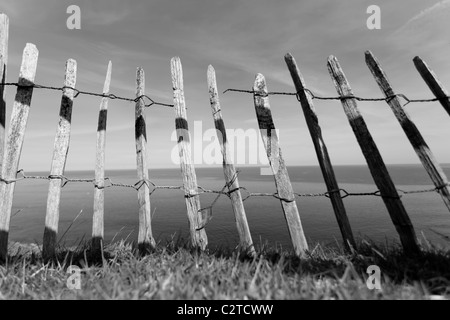 An old falling down fence protecting a cliff side path on the ...