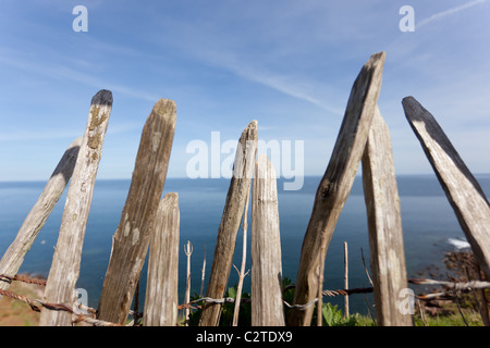 An old falling down fence protecting a cliff side path on the ...