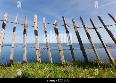 An old falling down fence protecting a cliff side path on the ...