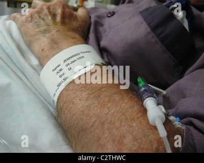 elderly mans arm in hospital with name tag and drip Stock Photo - Alamy