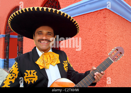 Charro Mariachi singer playing guitar in Mexico with white house ...