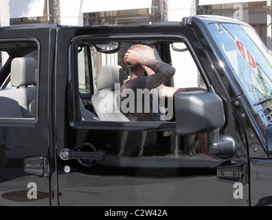 David Beckham covers his face as drives his custom Jeep through Beverly ...