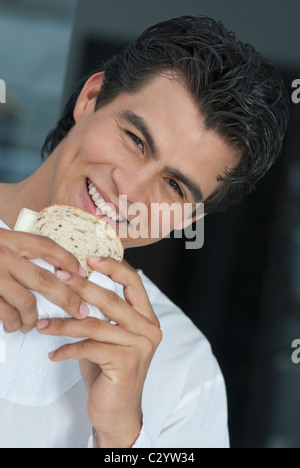 Hungry man eating. Sandwich outdoors. hiker eating sandwich sitting in ...