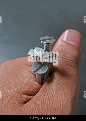 Hand holding bolts Stock Photo - Alamy