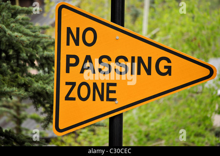 Triangular NO PASSING ZONE road or highway sign Stock Photo - Alamy