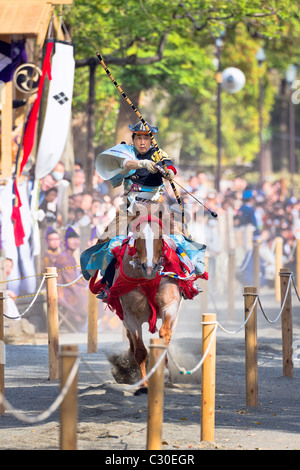 An Archer in Samurai Clothing prepares to shoot in a Horseback archery ...