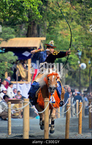 An Archer in Samurai Clothing prepares to shoot in a Horseback archery ...