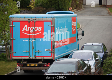 Argos home delivery van in a street with rear door open and man ...