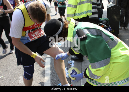 "St John Ambulance" volunteer provides medical assistance to runners on ...