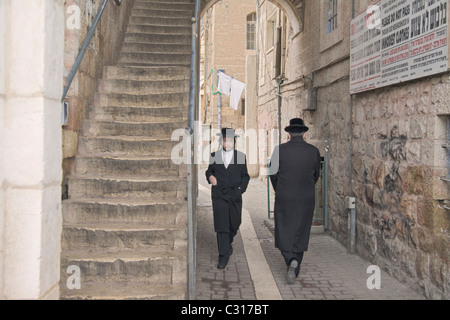 Two Hasidic orthodox Jews walking on Lee Ave carrying boxes. On A ...