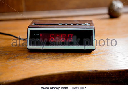 Digital alarm clock showing one minute to midnight Stock Photo ...