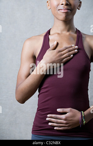 Women breathing deeply, touching chest Stock Photo - Alamy
