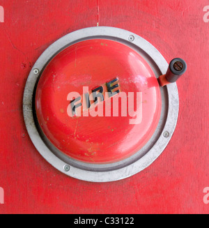 Red fire alarm bell mounted on a wall near the roof Stock Photo - Alamy