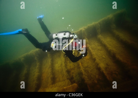 A diver on the wreck of the Empire Seaman, one of the blockships at ...