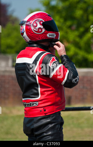 Man taking off his motorcycle helmet Stock Photo - Alamy