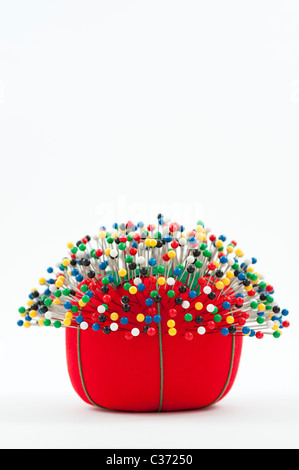 Red pin cushion with multi colored pins stuck in cushion Stock Photo ...