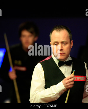 John Higgins in action against Judd Trump (not pictured) on day seven ...