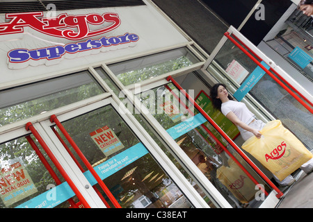 An Argos customer leaving a superstore with her purchase. Part of the ...