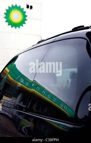 The BP logo at a petrol station with the BP Connect sign reflecting on ...