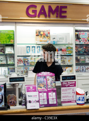 A member of staff serving a customer inside a Game store in North ...