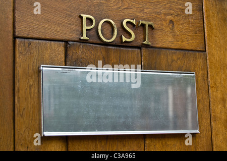 Brass mail slot on a wooden gate Stock Photo - Alamy