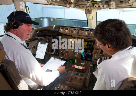 Pilot and co-pilot reviewing checklist before takeoff Stock Photo - Alamy