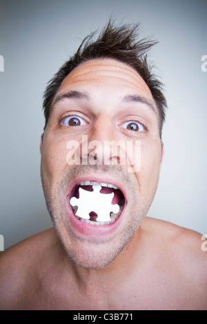 portrait of a man with jigsaw puzzle pieces Stock Photo - Alamy