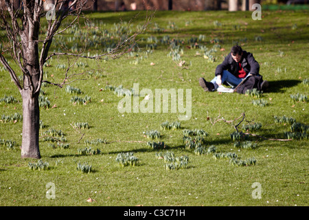 A man reads in the sun in London, Tuesday, June 23, 2026, as a heat ...