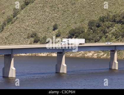 Tractor-trailer truck crossing a river on bridge Stock Photo - Alamy