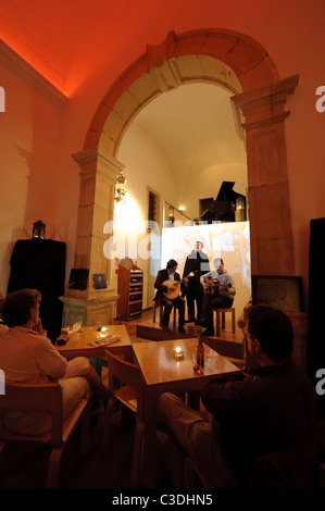 Live Fado performance in an intimate venue with guitarist and vocalist ...