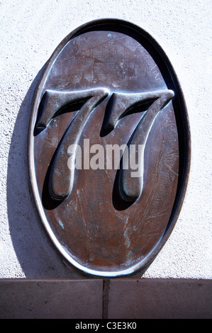 House number 77 with the seventy-seven in metal digits on a wooden ...