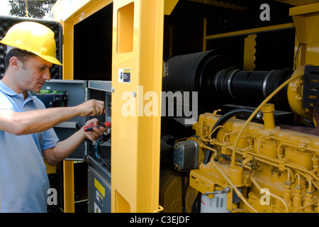 Technician is fixing the problem on generator Stock Photo - Alamy