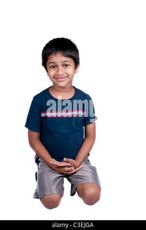 An Indian girl child practicing yoga padmasana on yoga mat outdoors ...
