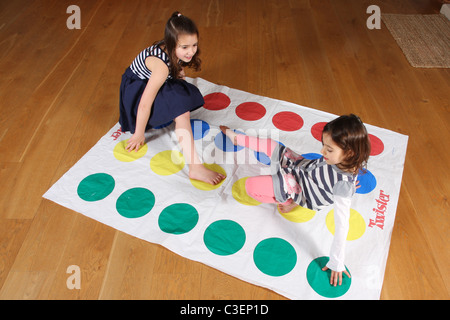 Sisters playing Twister at home Stock Photo - Alamy