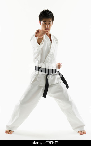 Karate man with black belt posing, champion of the world on black ...