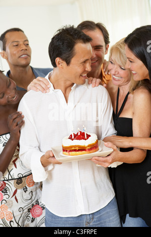 Happy man with birthday cake on color background Stock Photo - Alamy
