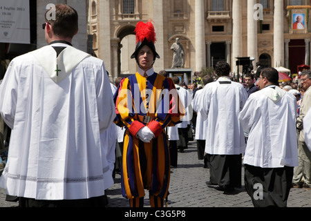 Priests giving out holy communion to faithful in Saint Peter's square ...
