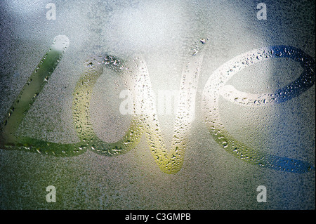 Love written in condensation on a glass window pane Stock Photo - Alamy
