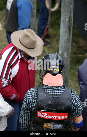 Cowboy, Bull rider with protective helmet with face mask is composing ...