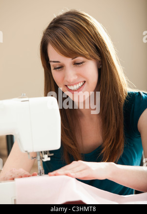 Woman with a sewing machine Stock Photo - Alamy