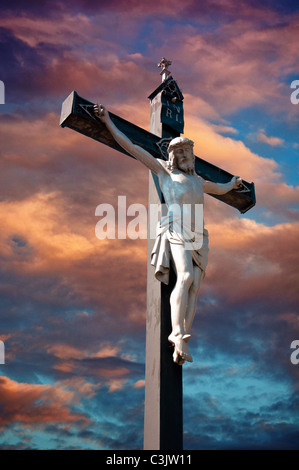 A statue of Jesus Christ crucified against some trees. Jesus Christ on cross. Jesus christ ...