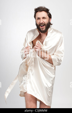 Man wearing silk robe, pulling face Stock Photo - Alamy
