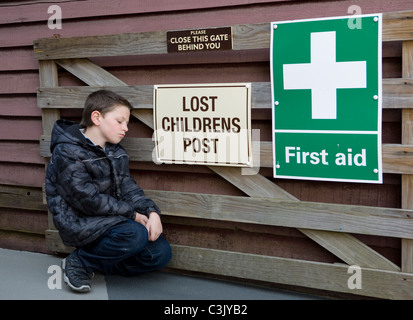 First aid post lost children Information point sign on black shed Stock ...