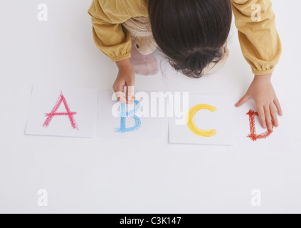 Girl lining up alphabet cards Stock Photo - Alamy