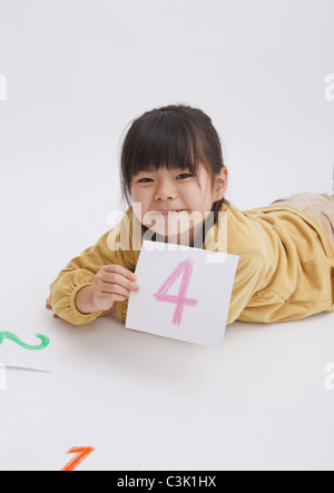 Girl holding number cards Stock Photo - Alamy