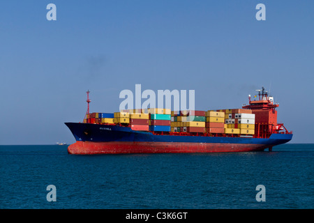 A container ship entering Port Sultan Qaboos in Muscat, Oman Stock ...