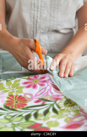 Hand Cutting Cloth with Scissors Stock Photo - Alamy