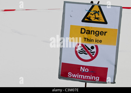 Danger Thin Ice signs over frozen water Stock Photo - Alamy