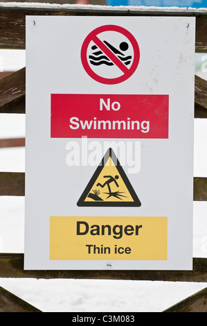 Danger Thin Ice signs over frozen water Stock Photo - Alamy